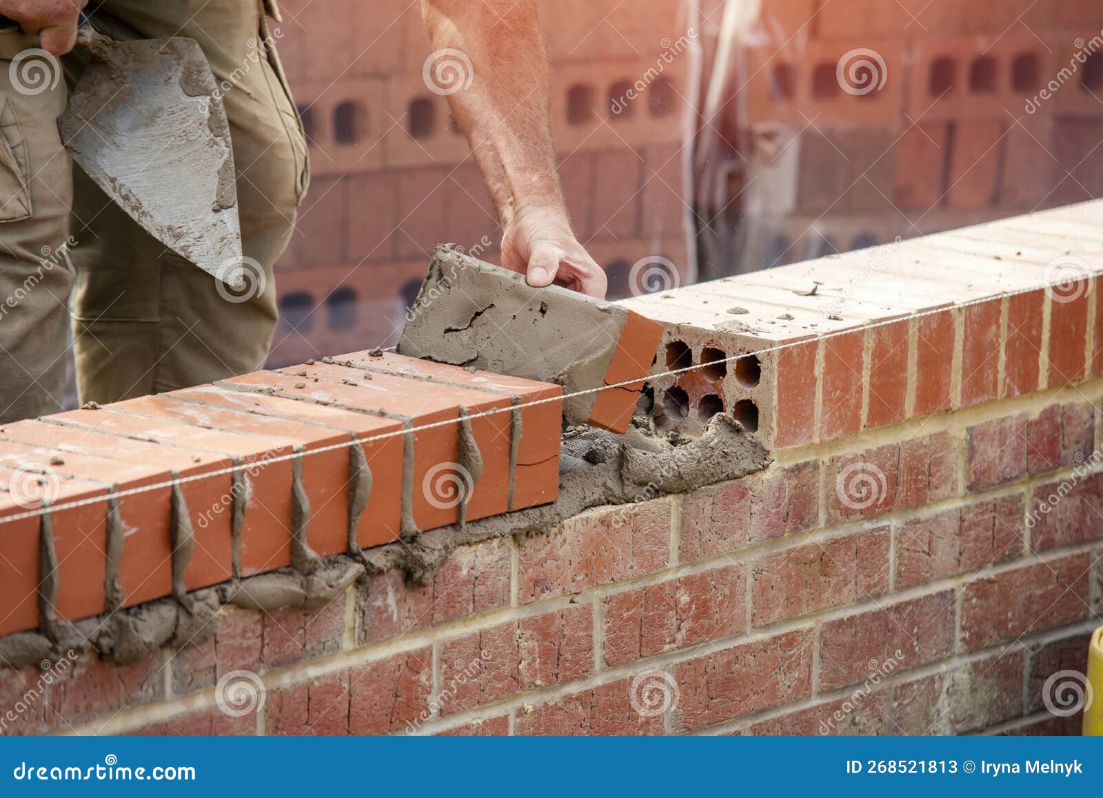 Industrial Bricklayer Laying Bricks on Cement Mix on Construction Site ...