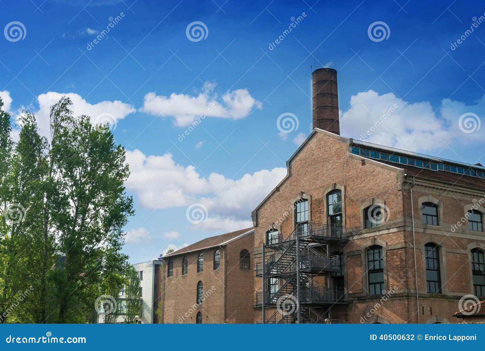 Industrial Building with a Tower and Trees Stock Photo - Image of ...