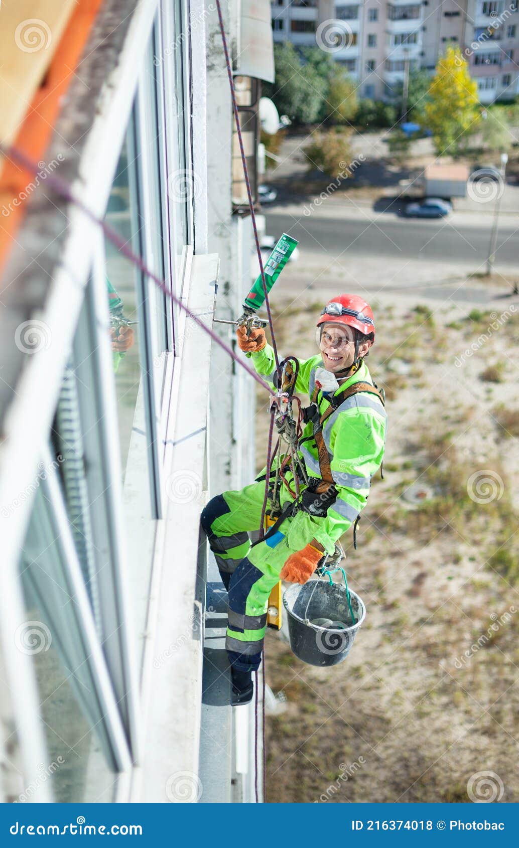 Industrial Climber on Building during Winterization Works, Looking Up ...