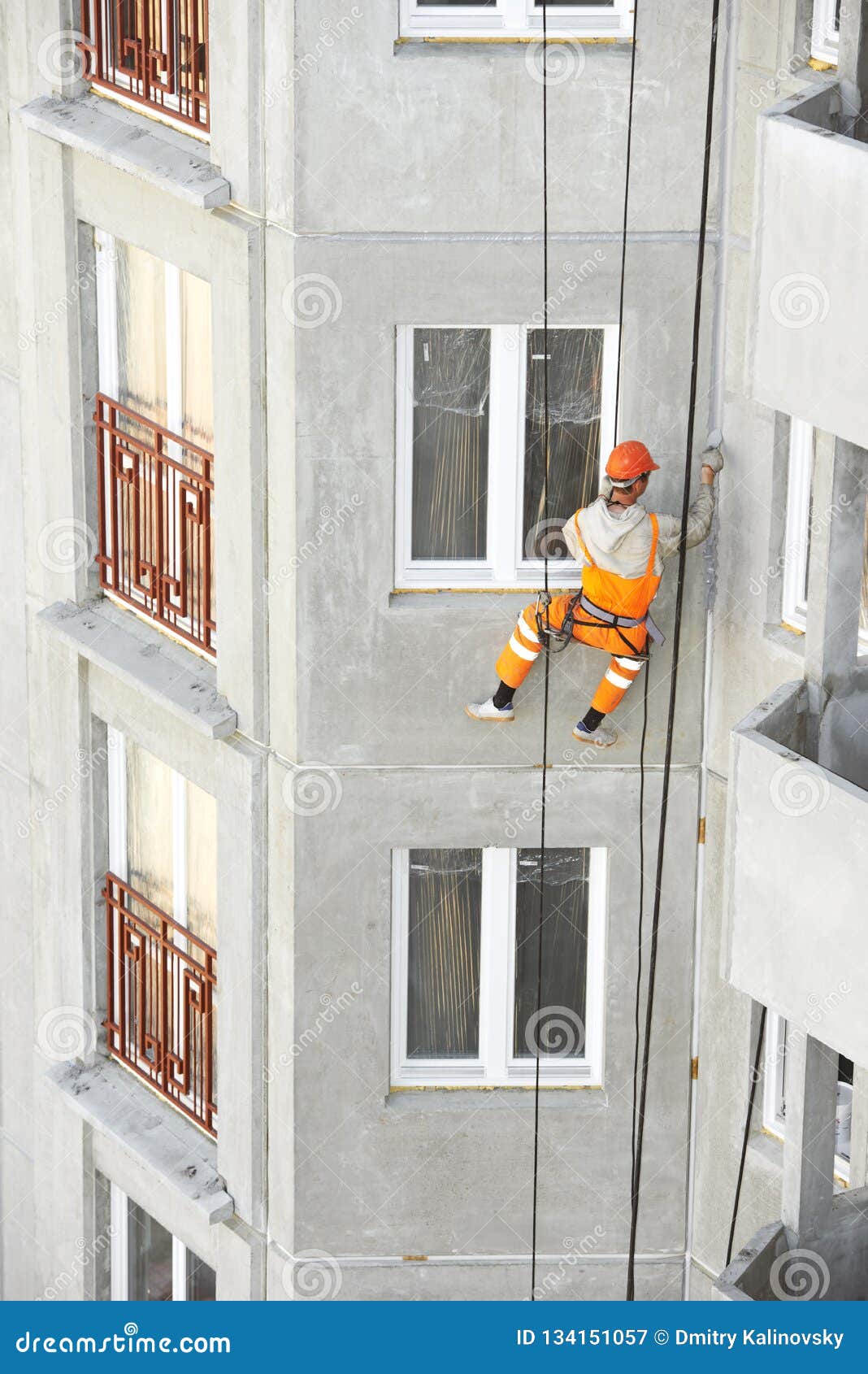 Industrial Climber. Builder Sealing Outside Facade Building Seam Joints ...