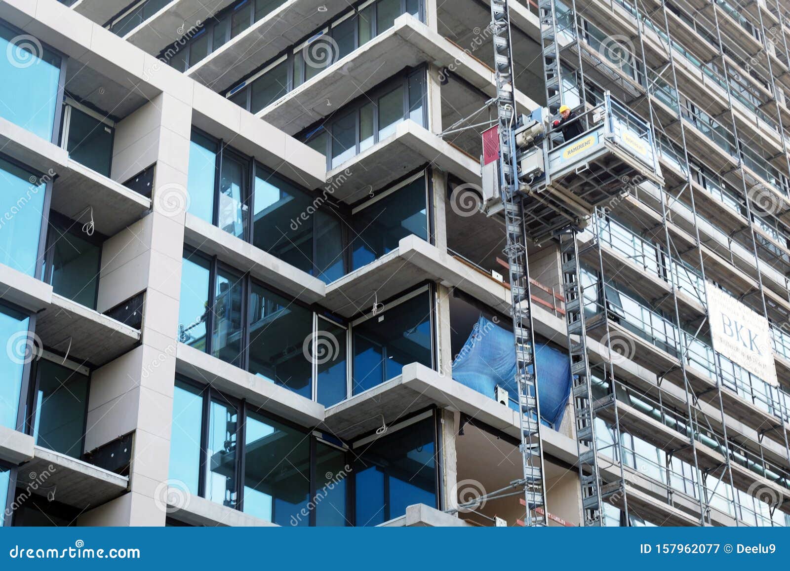 Industrial Construction Lift Taking Up a Builder on Building Site of ...