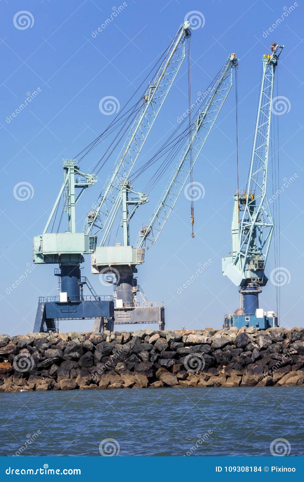 Industrial Cranes on a Loading and Unloading Dock Stock Photo - Image ...