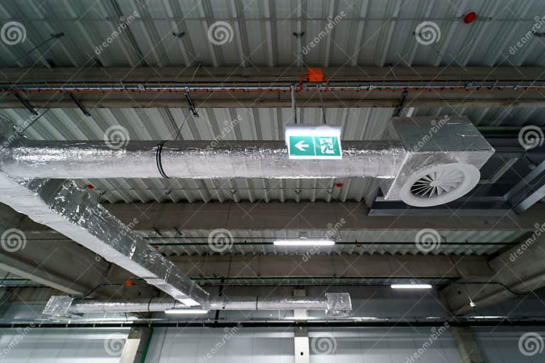 Industrial Duct System with Emergency Exit Sign Stock Photo - Image of ...