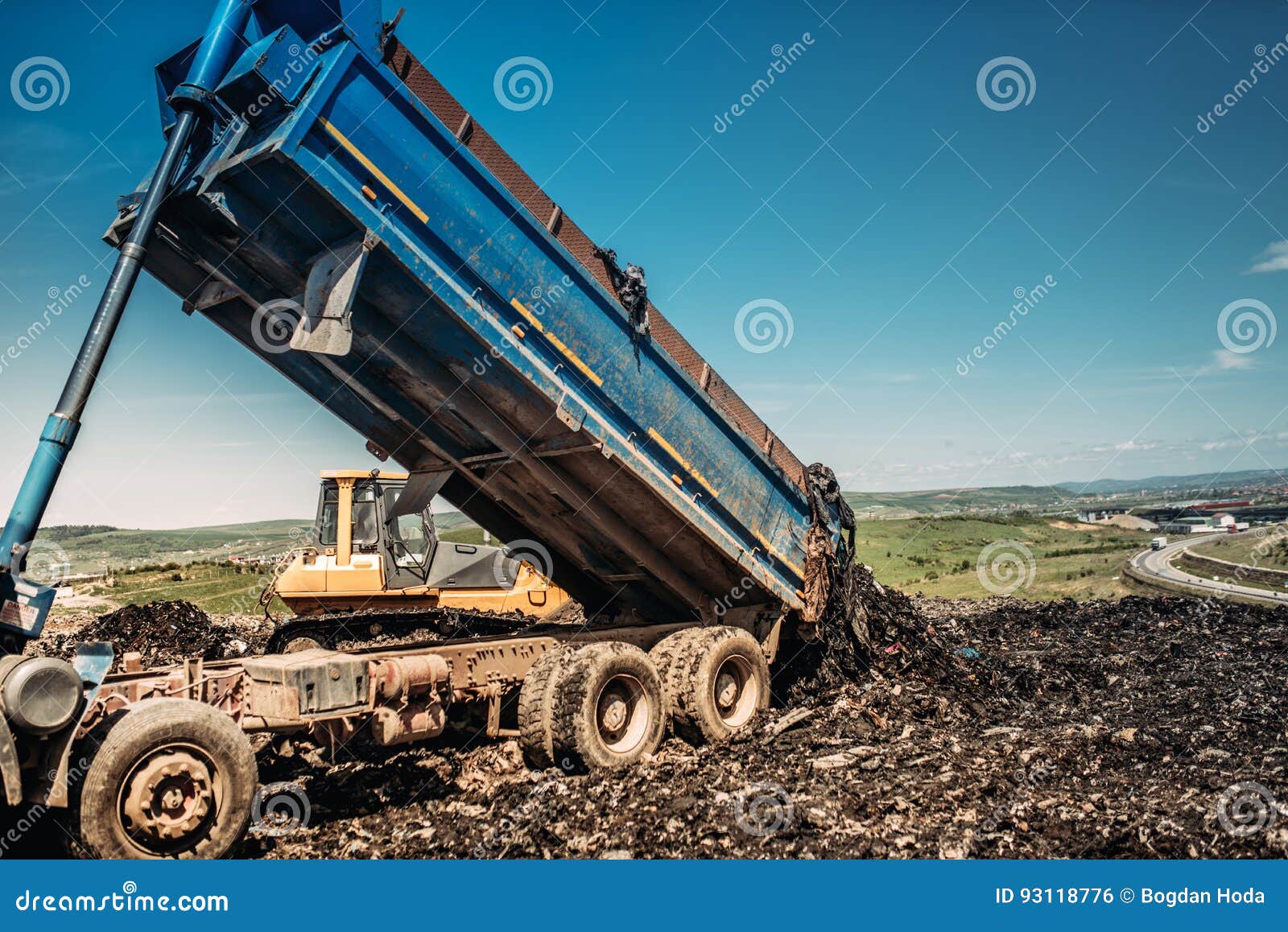 Industrial Dumper Trucks Unloading Garbage into Trash Hill Stock Photo ...
