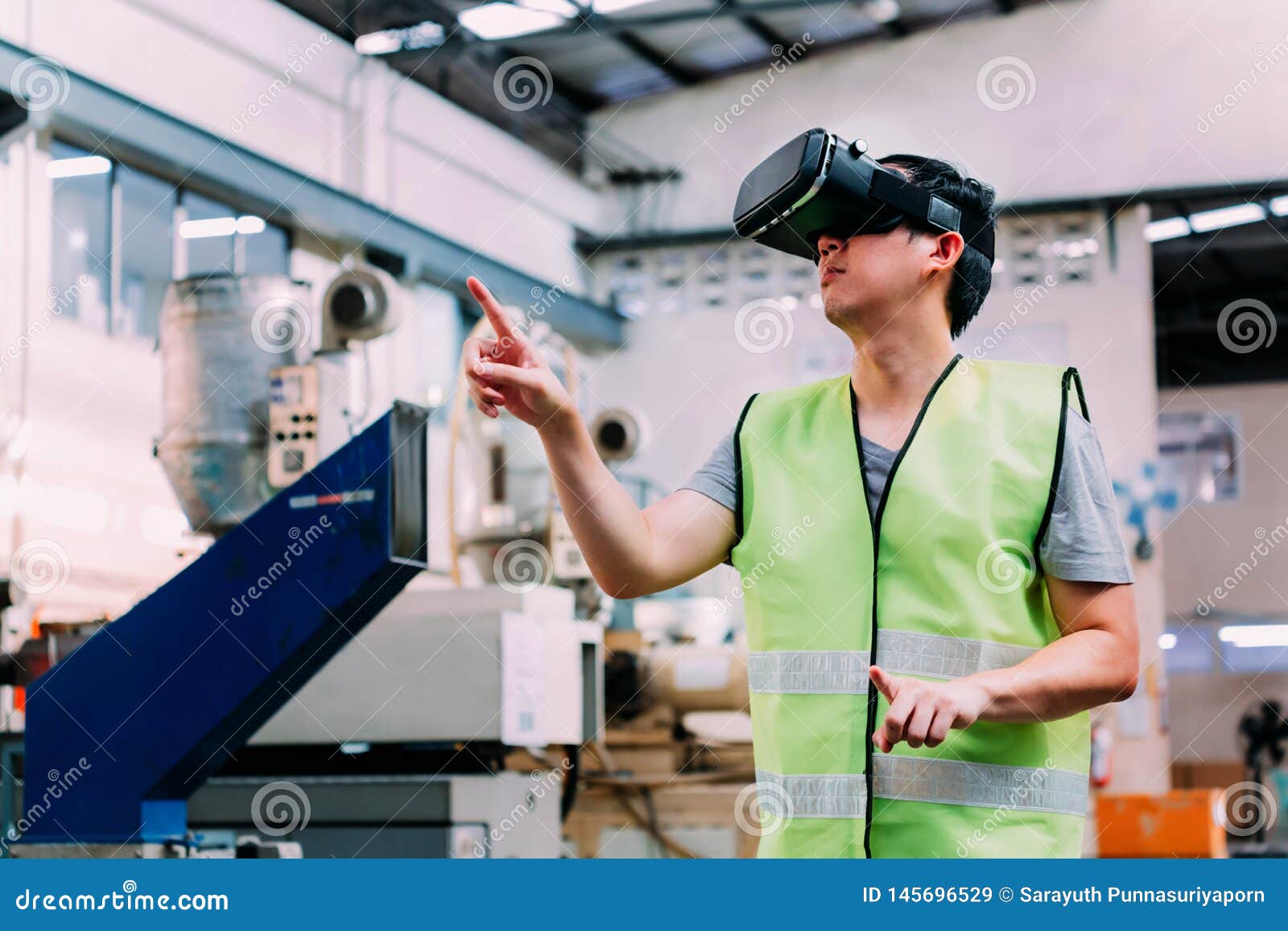 Industrial Factory Worker Wearing VR Goggle Touching in Virtual Reality ...