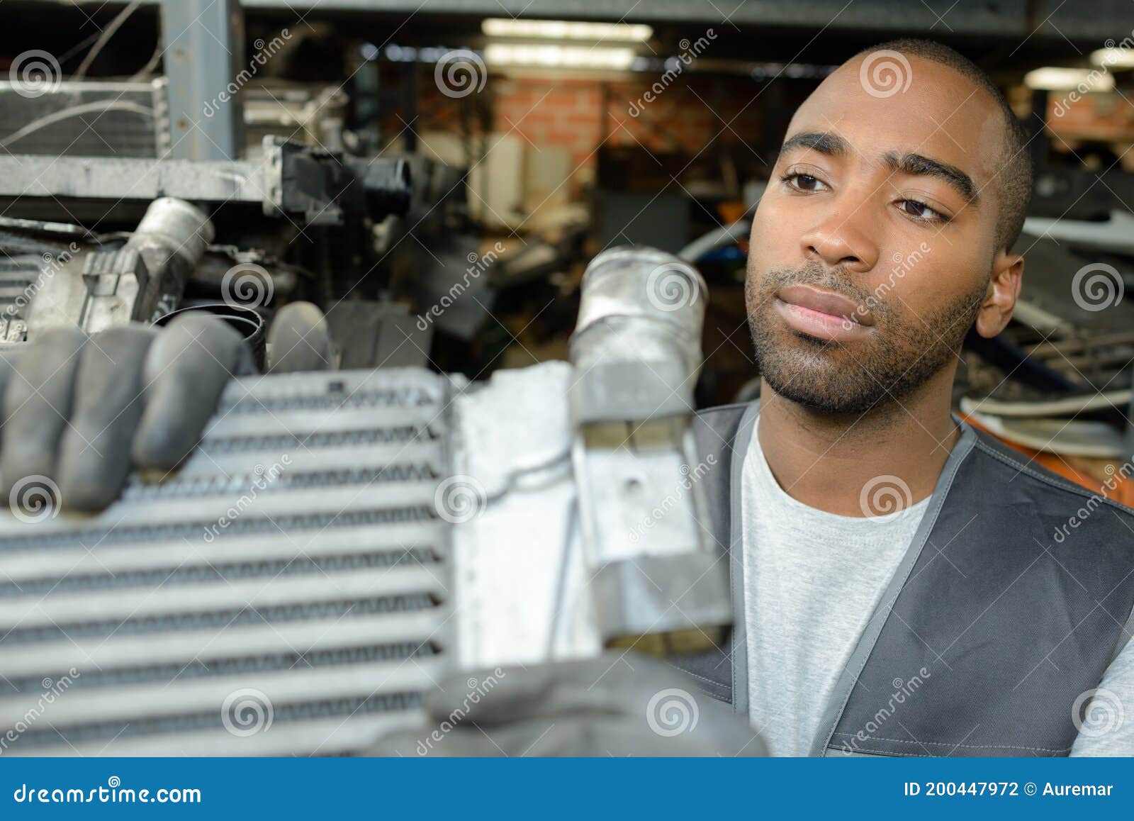 Man In Overalls Operates An Electric Stacker Loaded With Boxes Stock ...