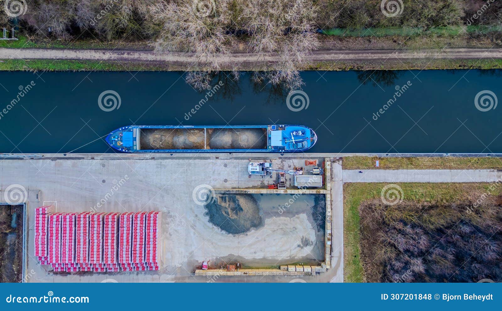 Industrial Harmony: Cargo Ship Docked at Riverside Depot Stock Photo ...