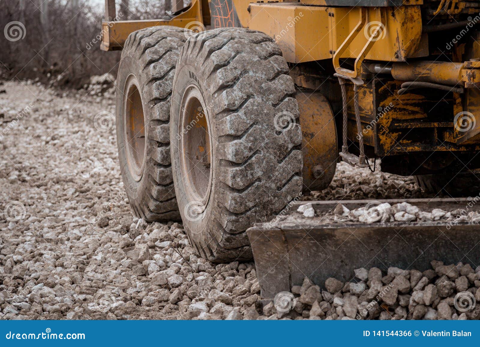 Industrial Machine Moving Gravel on a Road. Stock Photo - Image of ...