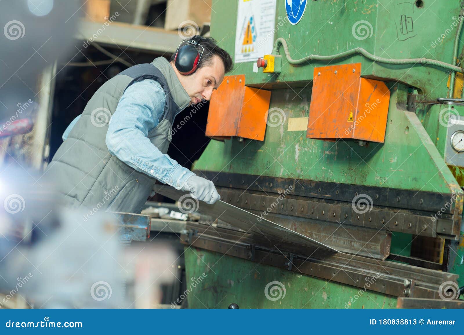 Industrial Metal Worker Inserting Material into Machine Stock Image ...