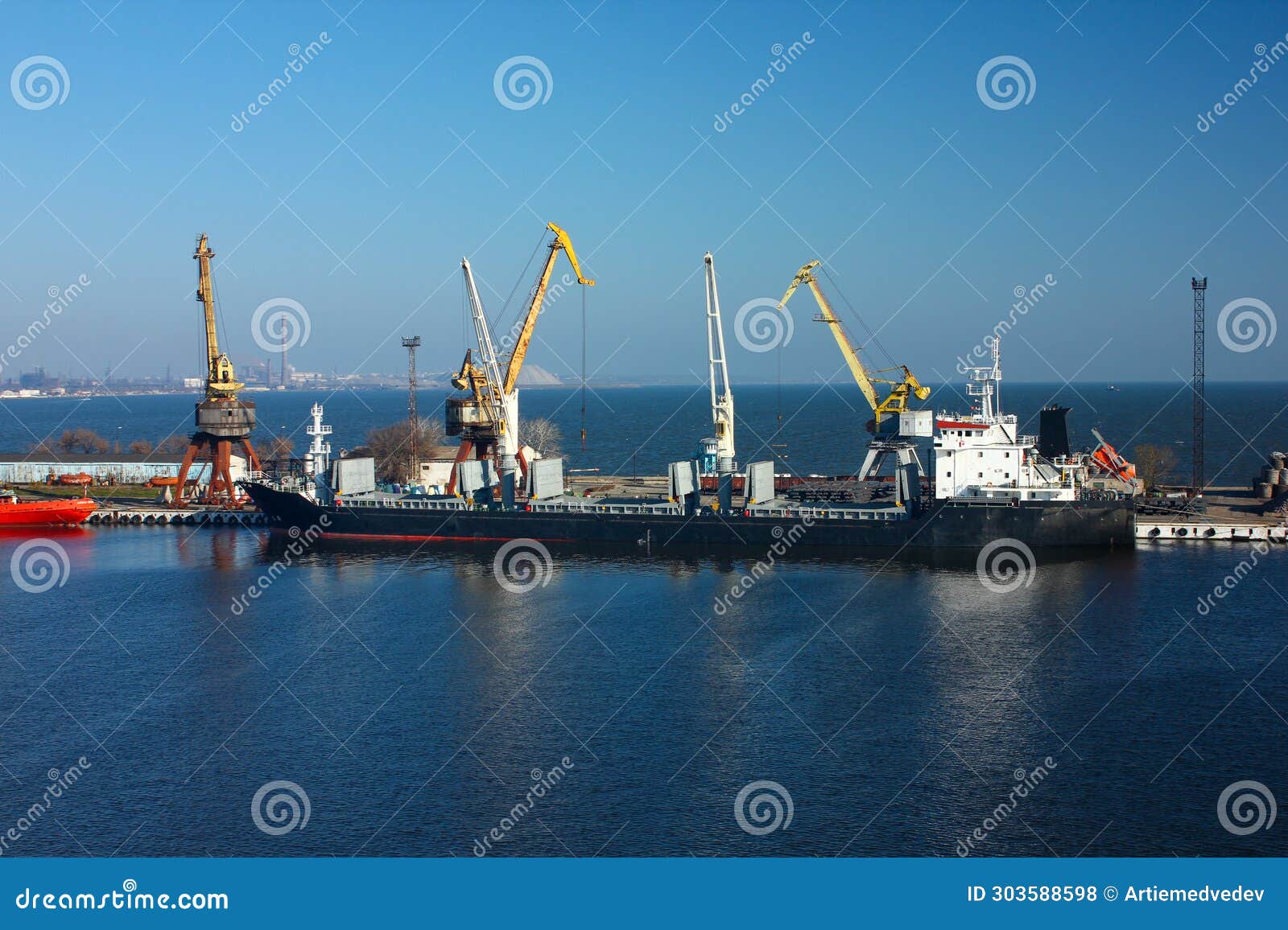 Cargo Ship Loading at the Dock with Multiple Cranes. Industrial ...