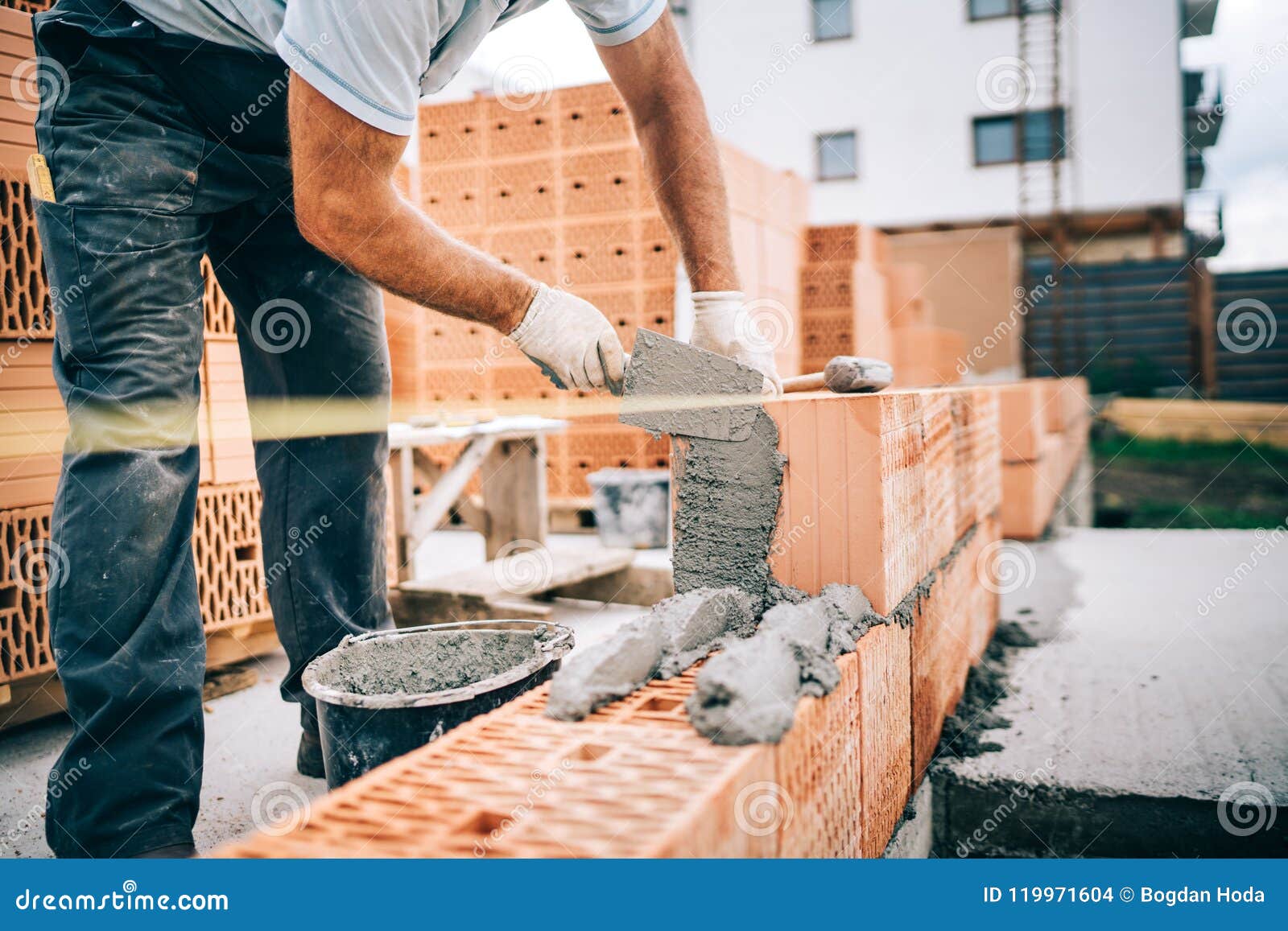 Industrial Worker, Bricklayer Installing Bricks on Construction Site ...
