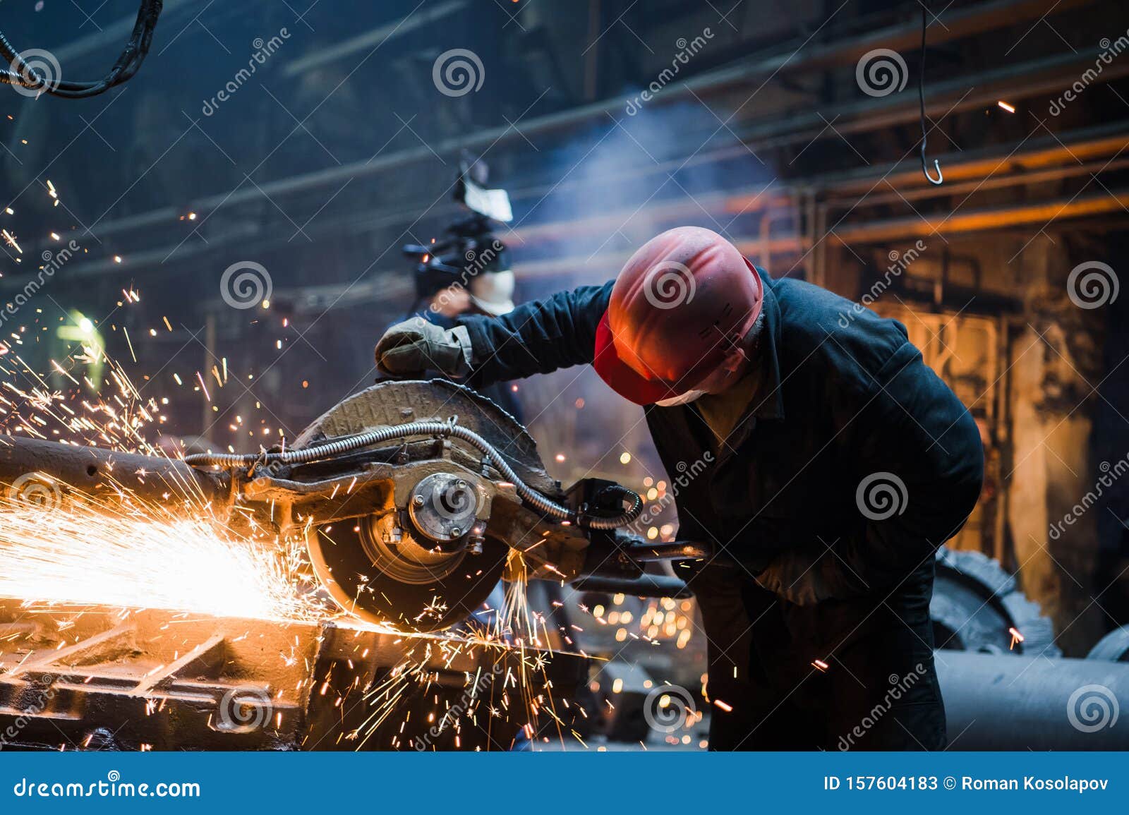Industrial Worker Cutting and Welding Metal with Many Sharp Sparks ...