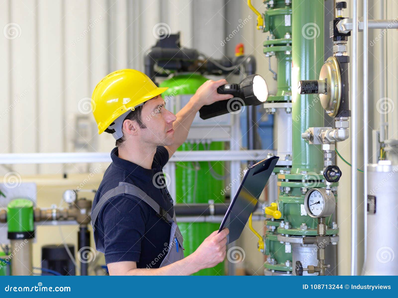 Industrial Worker Inspects and Repairs a Heating System in a Factory ...