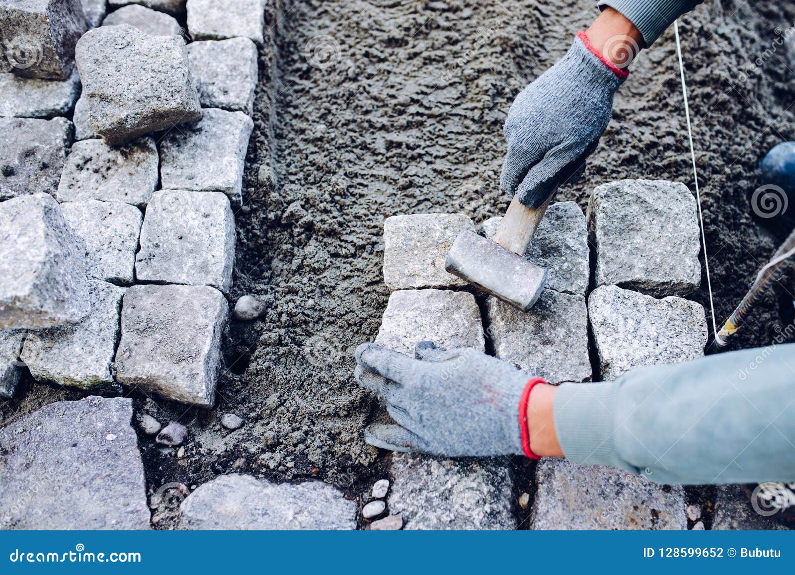 Industrial Worker Installing Pavement Rocks, Cobblestone Blocks Stock ...