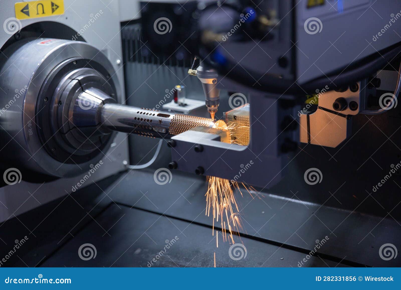 A Machine Working on a Large Item of Equipment with Sparks from the ...