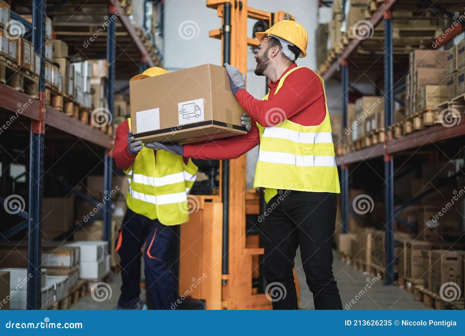 Industrial Workers Loading Delivery Box Inside Warehouse Store - Focus ...