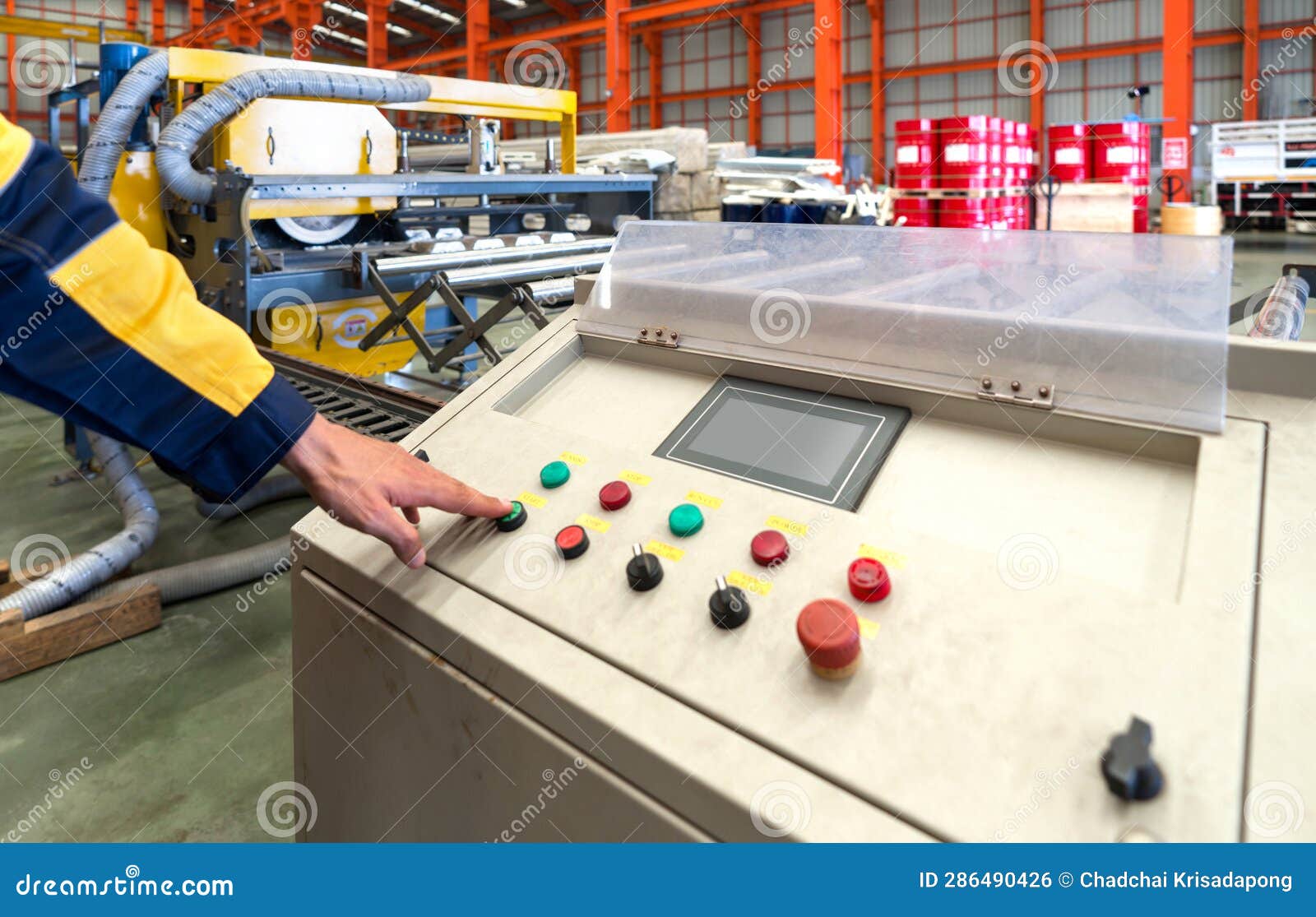 Industrious Worker Meticulously Operating Complex Machinery within a ...