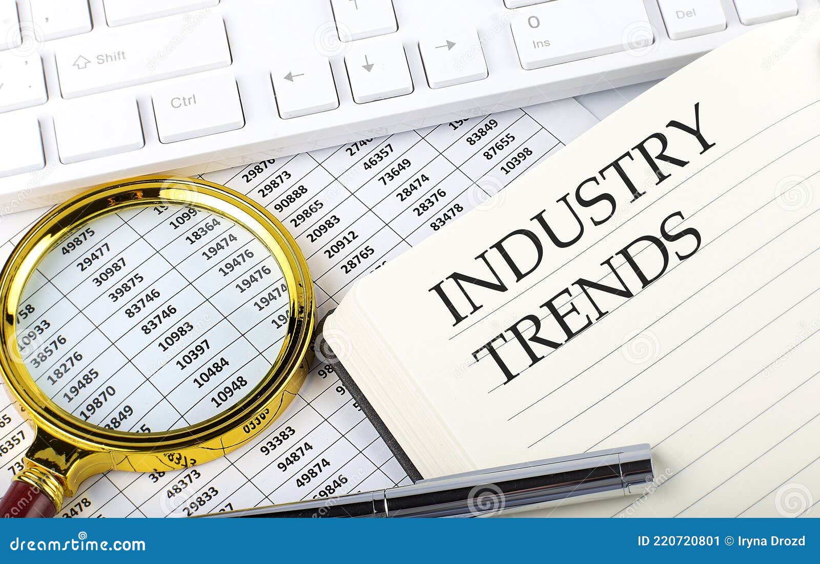 INDUSTRY TRENDS Text on the Notebook with Chart, Magnifier,keyboard and ...