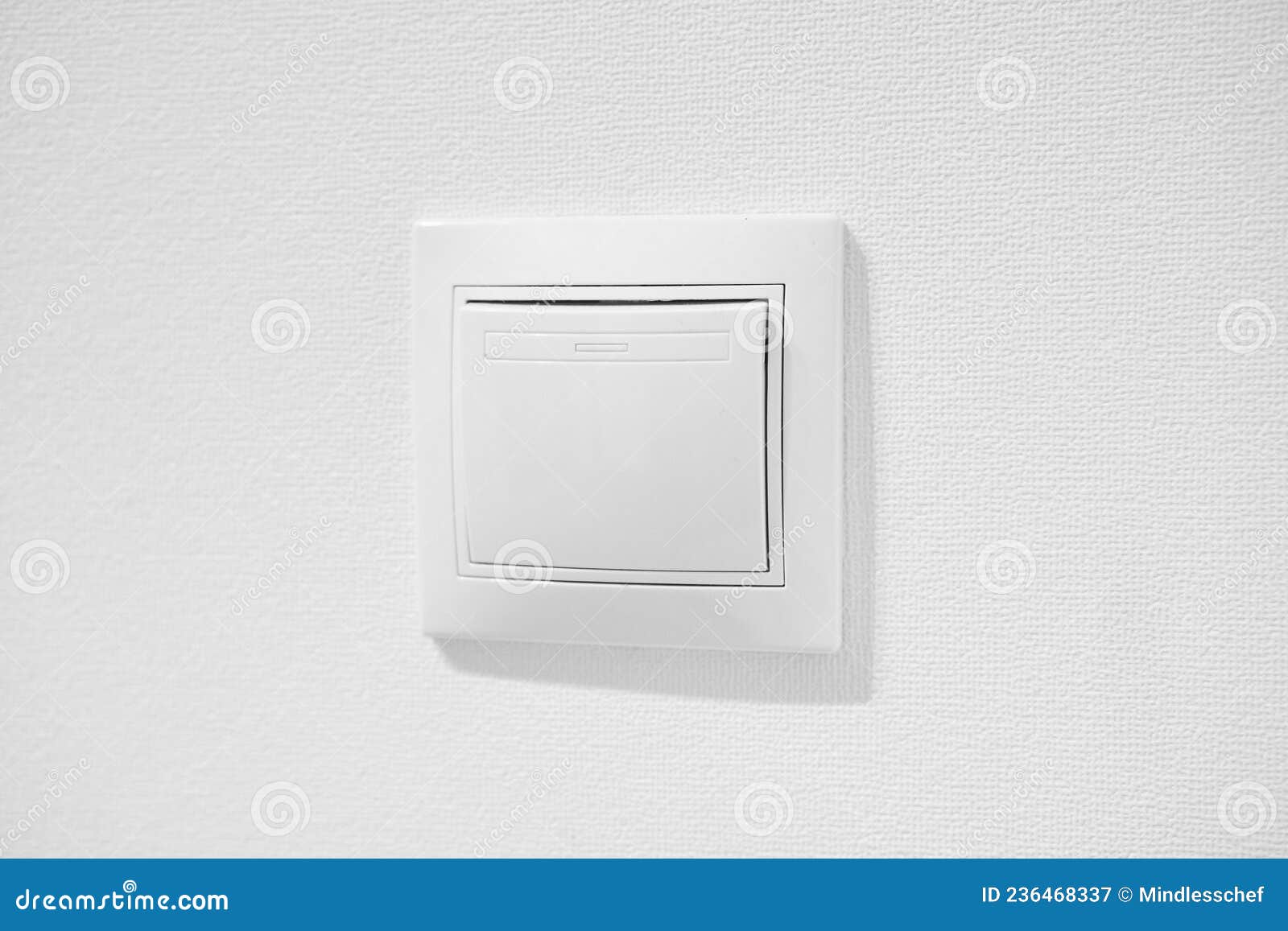 Inexpensive Plastic Push Button Switch Against White Wall. White Common ...