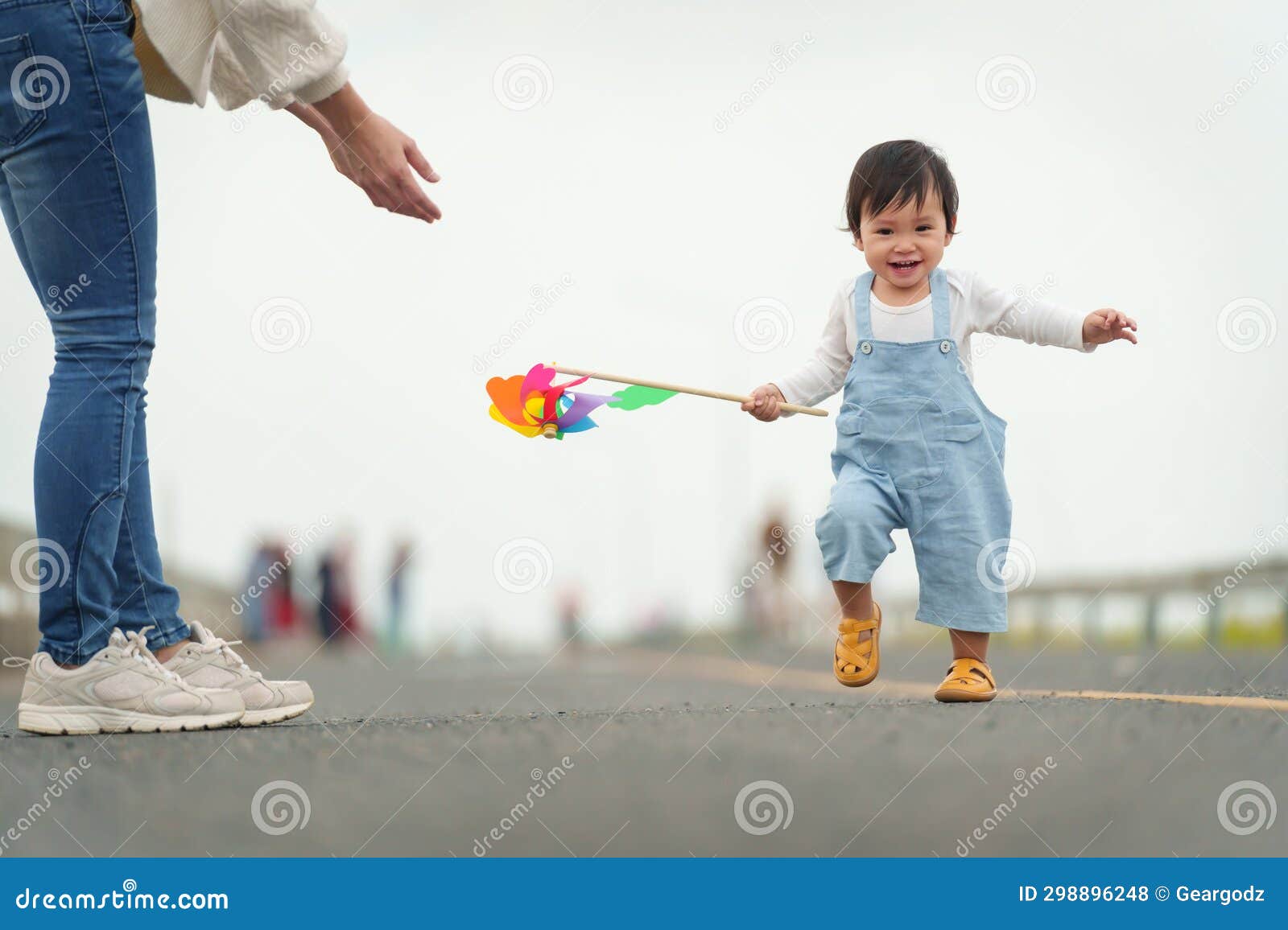 Infant Baby Learn Walking First Step on Pathway with Mother Helping ...