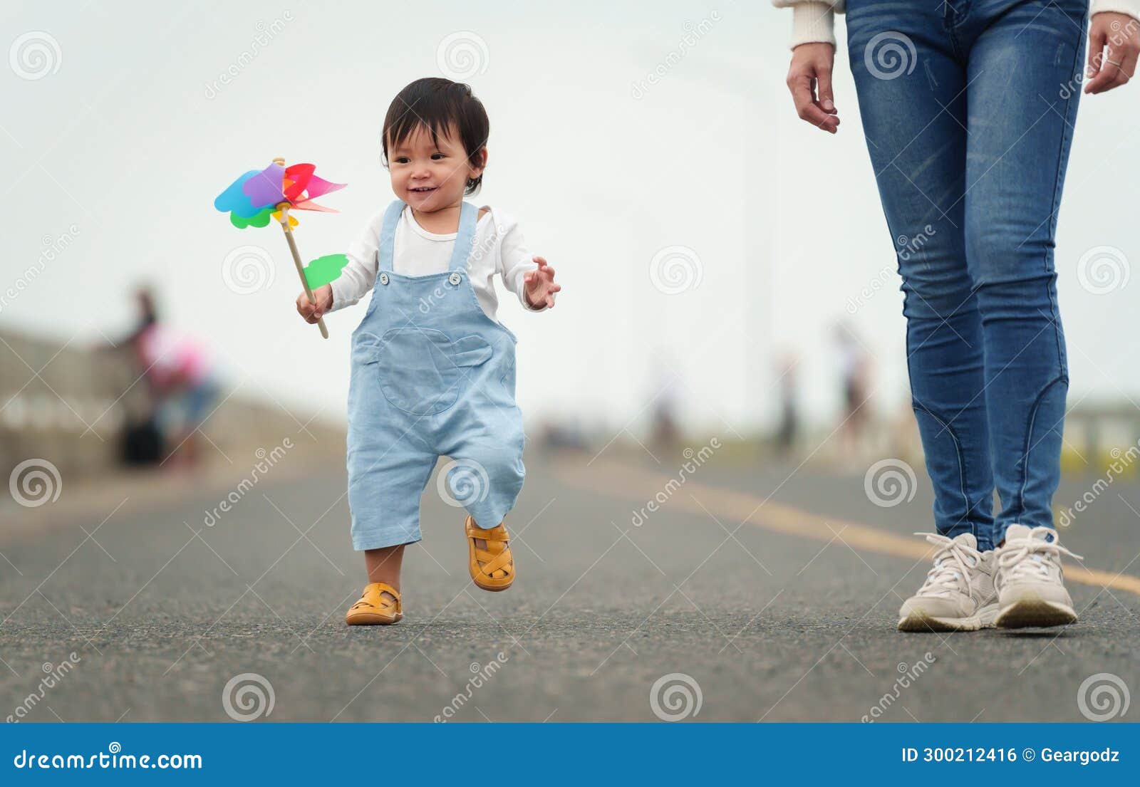 Infant Baby Learn Walking First Step on Pathway with Mother Helping ...