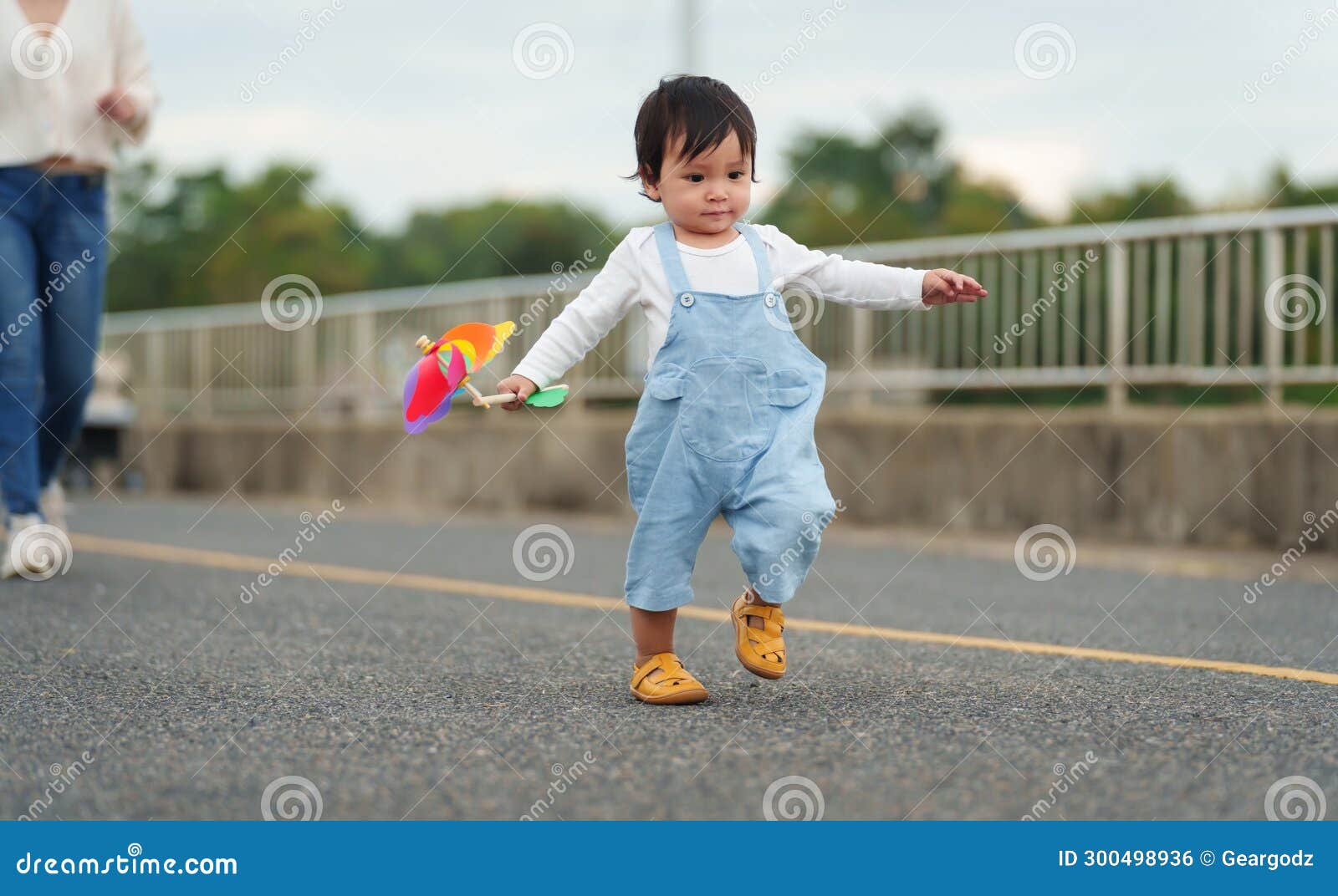 Infant Baby Learn Walking First Step on Pathway with Mother Helping ...