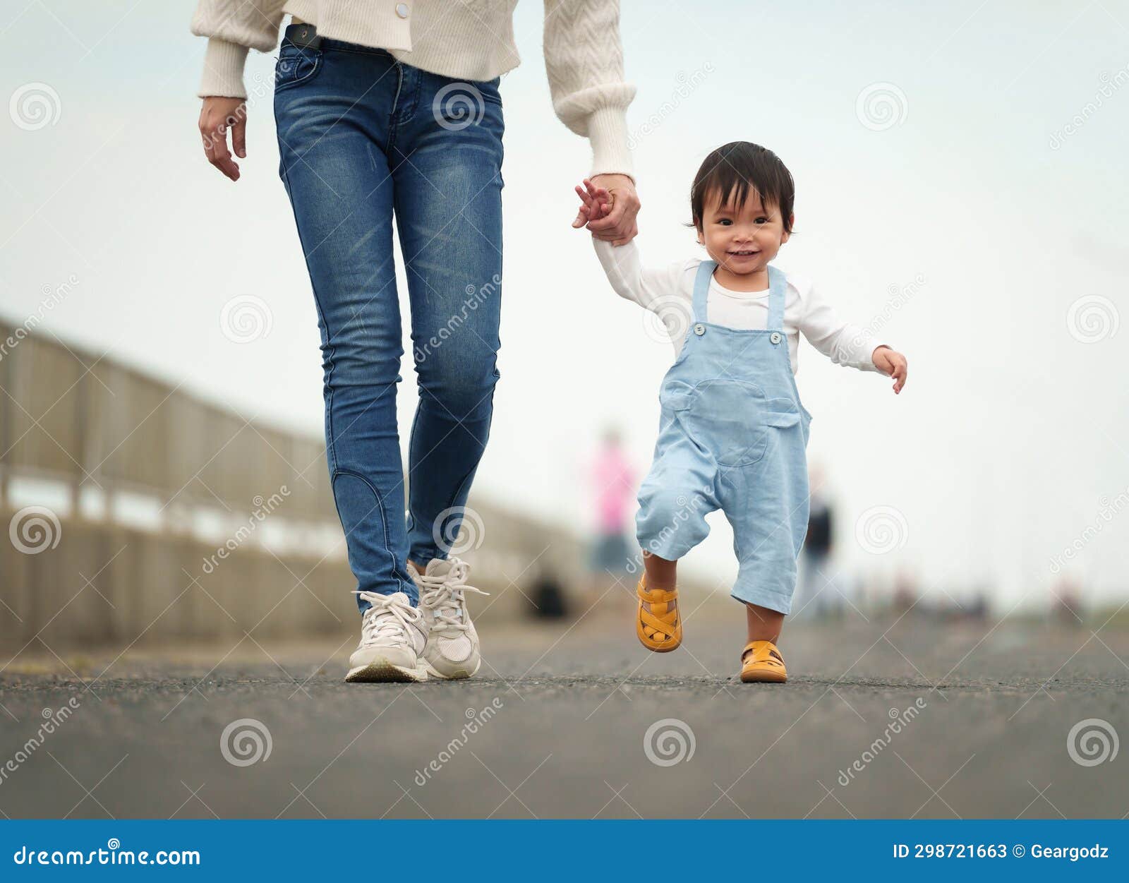 Infant Baby Learn Walking First Step on Pathway with Mother Holding ...
