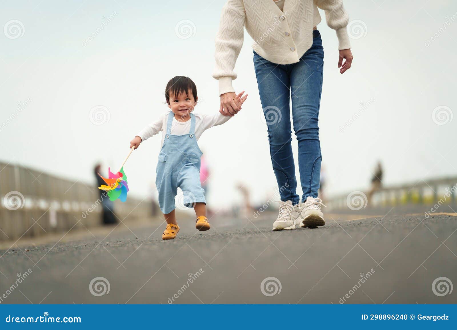Infant Baby Learn Walking First Step on Pathway with Mother Holding ...