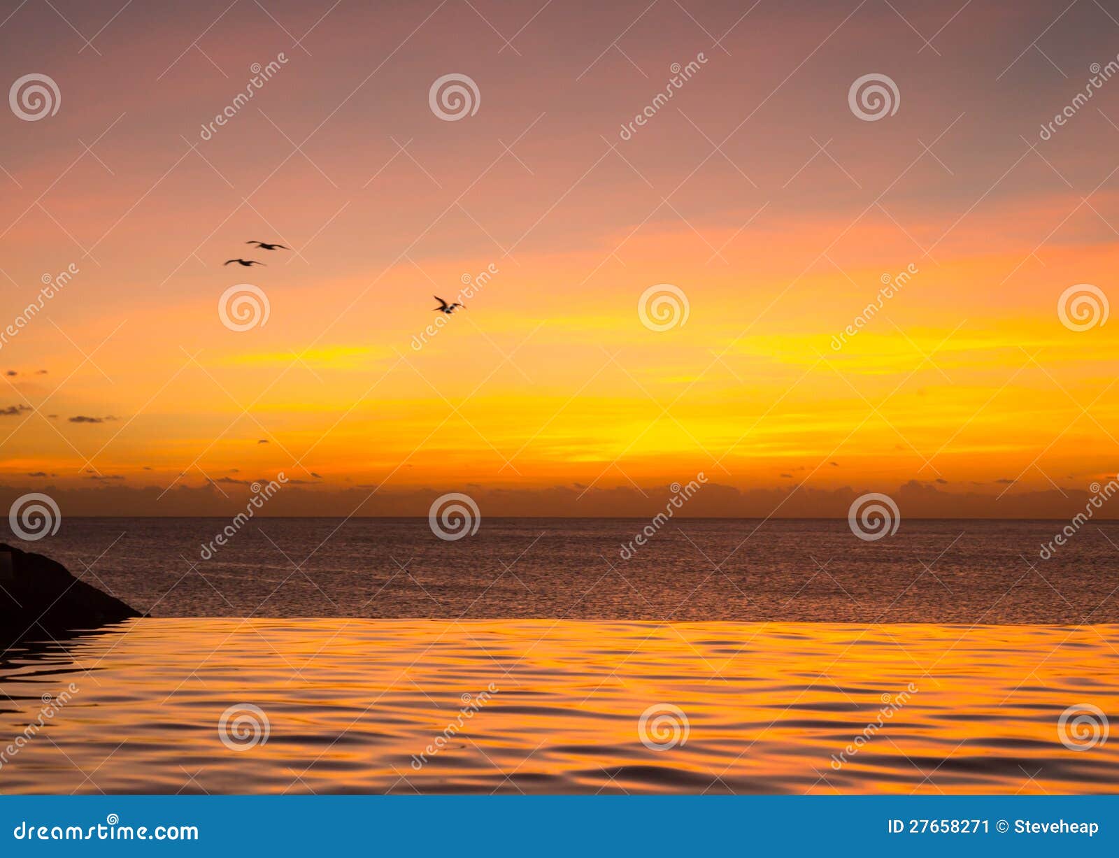 Infinity Edge Pool with Sea Underneath Sunset Stock Image - Image of ...