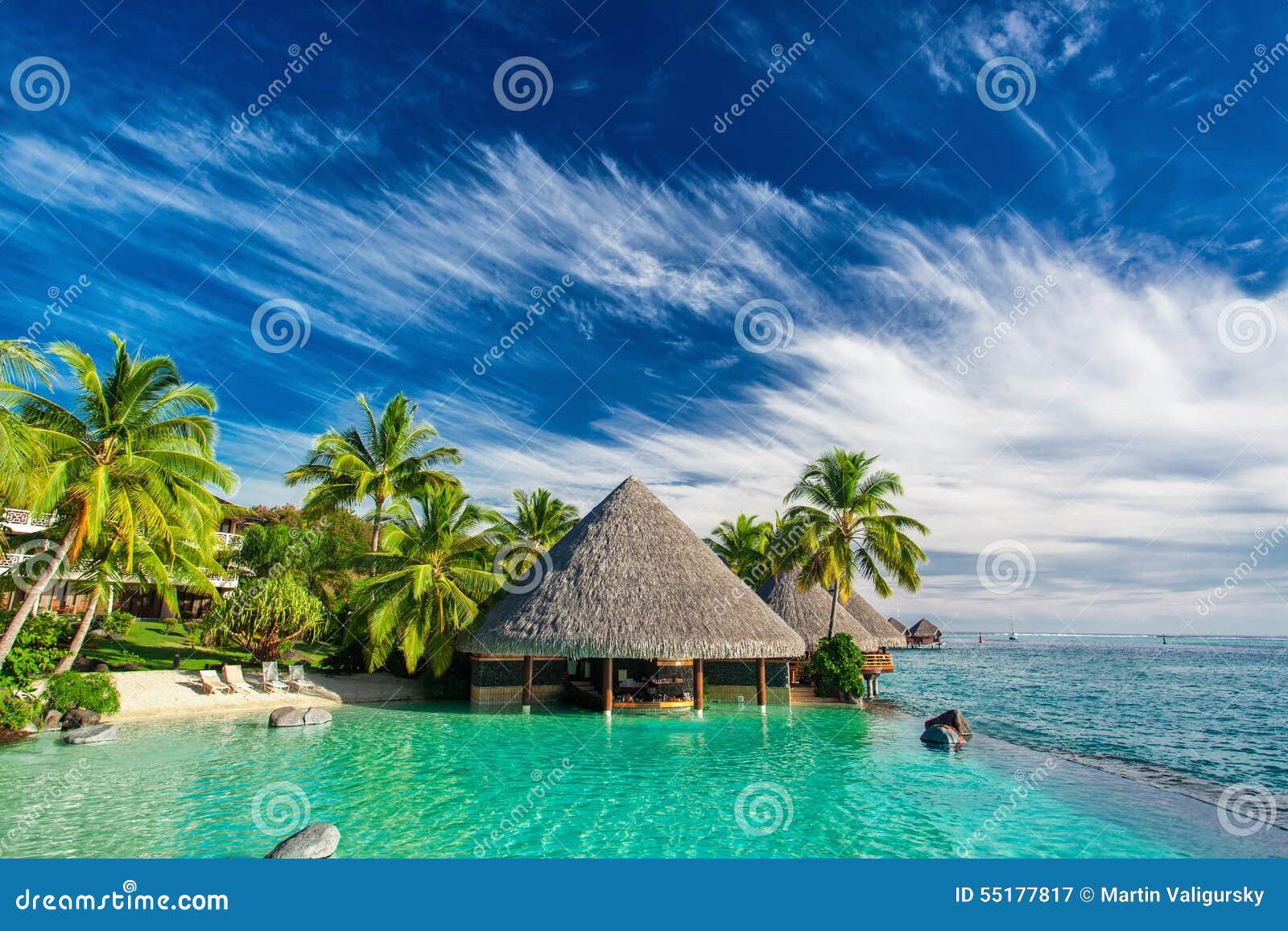 Infinity Pool with Artificial Beach and Bar Next To Tropical Ocean ...