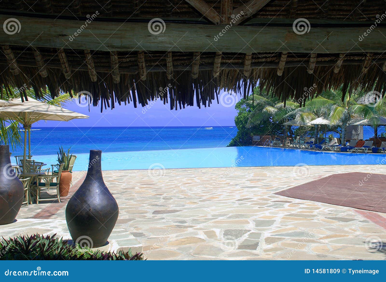 Infinity Pool Overlooking Tropical Ocean Stock Image - Image of tables ...