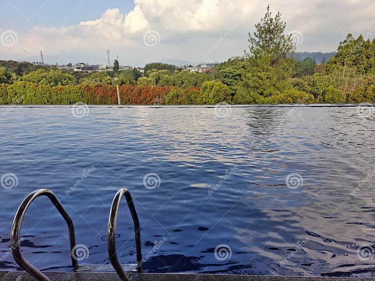 Infinity swimming pool stock image. Image of morning - 323734907