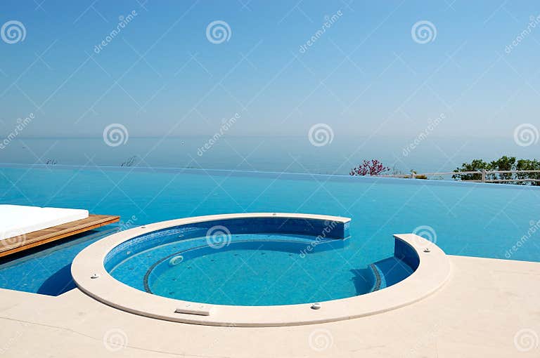 Infinity Swimming Pool with Jacuzzi by Beach Stock Photo - Image of ...
