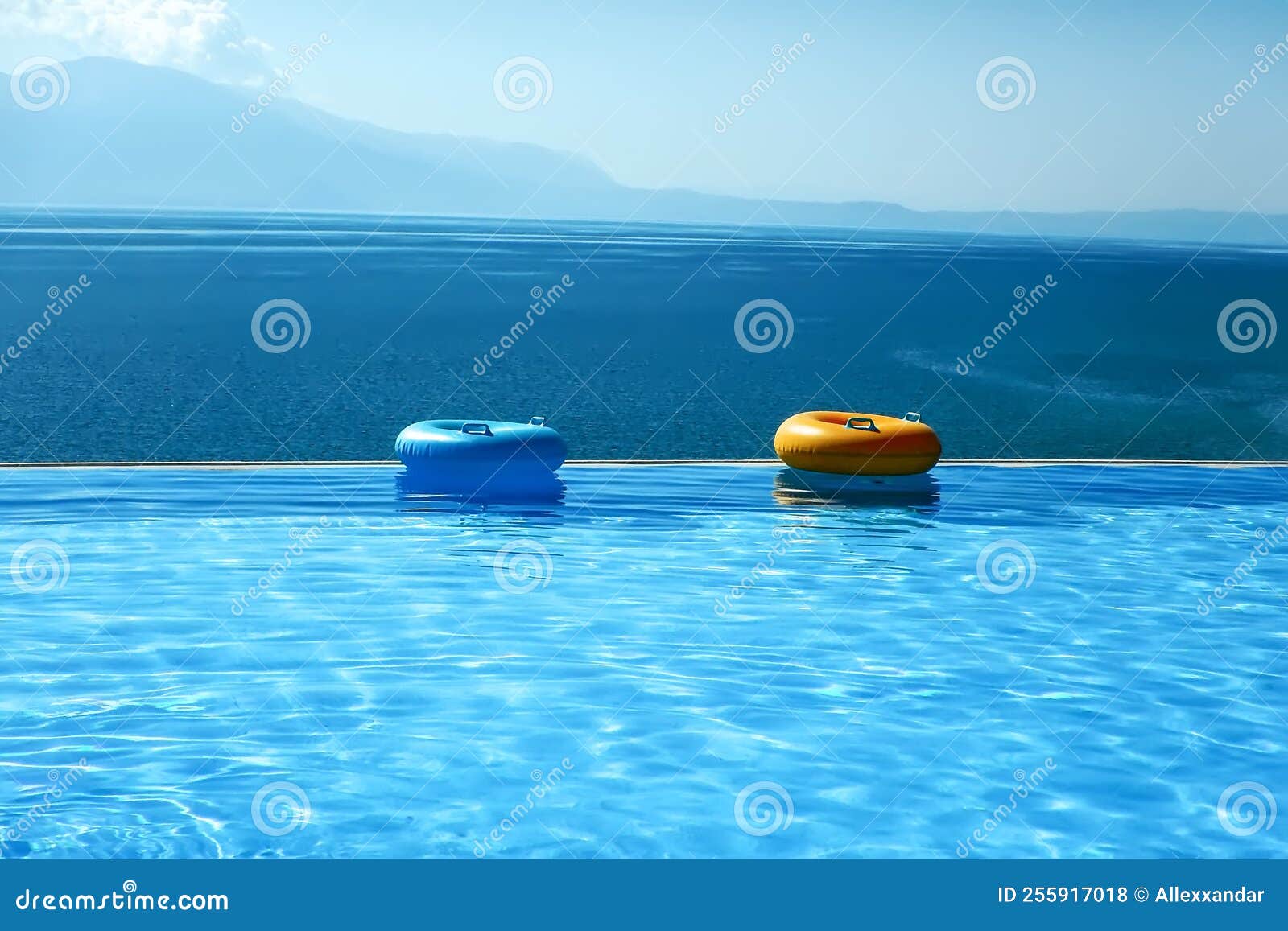 Infinity Swimming Pool with Sea and Mountain View Stock Photo - Image ...