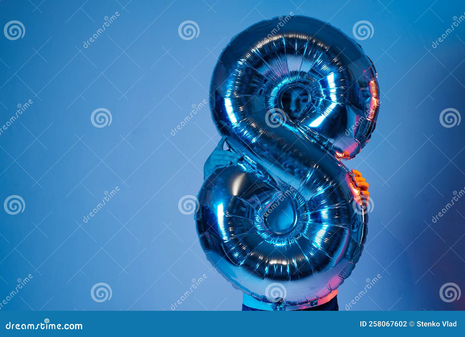 Inflatable Ball Eight in Neon Light Holds a Boy Stock Photo - Image of ...