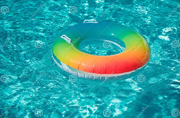 Inflatable Rubber Ring Floating in a Blue Pool. Stock Photo - Image of ...