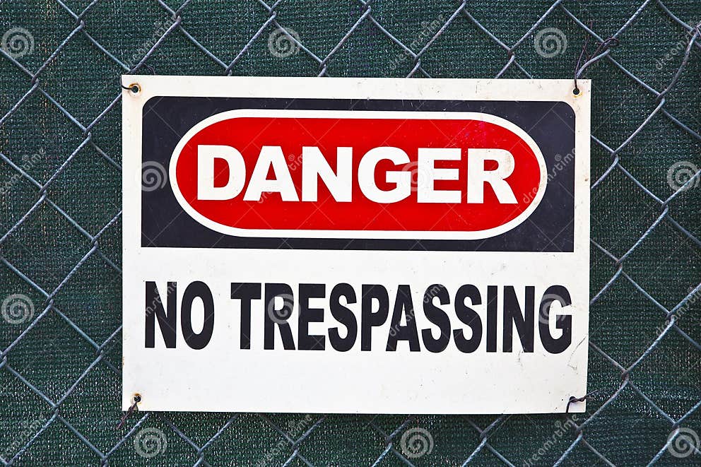 Information Medium with Danger and No Trespassing Text Against a Wire ...