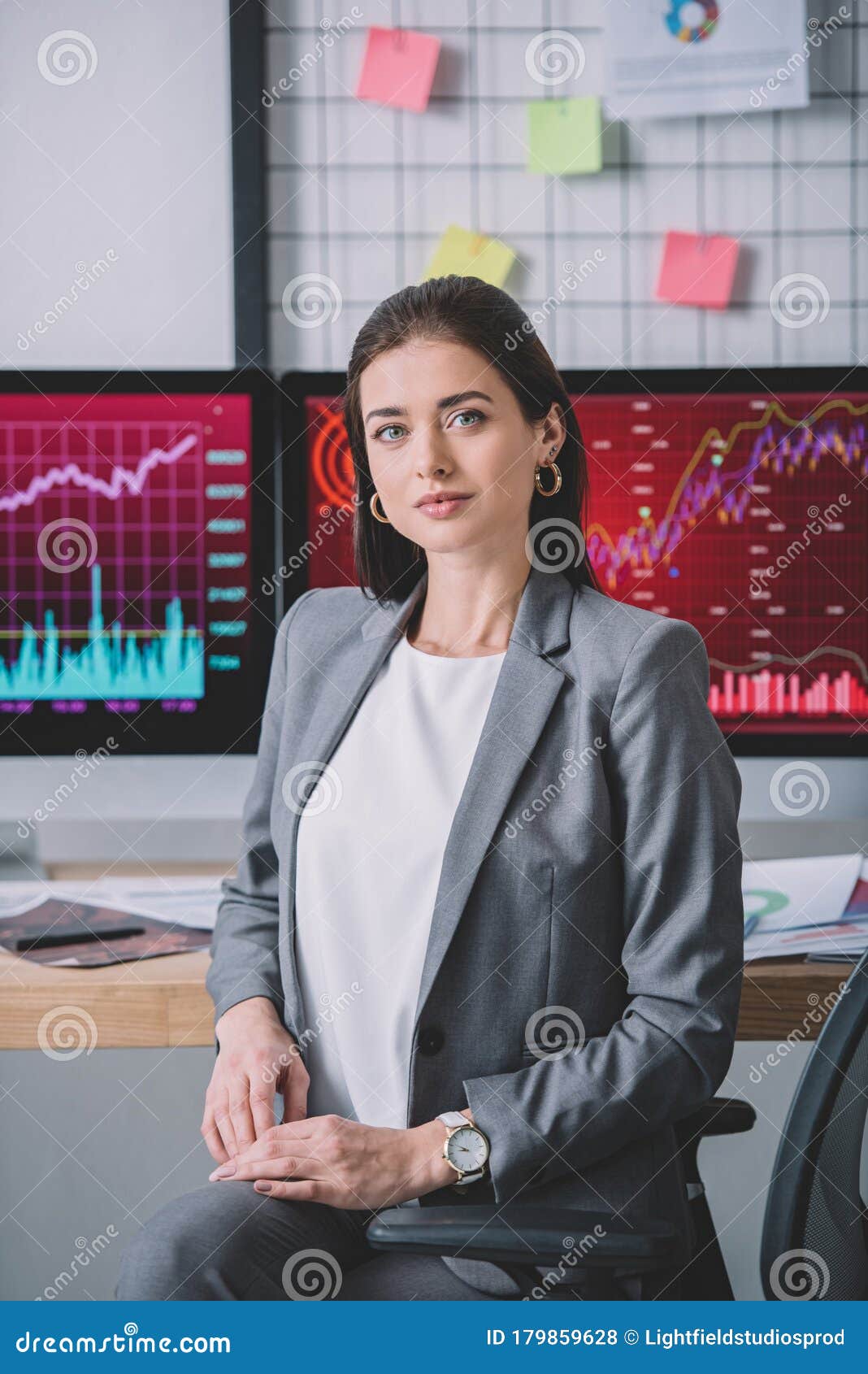 Information Security Analyst Looking at Camera Near Graphs on Computer ...