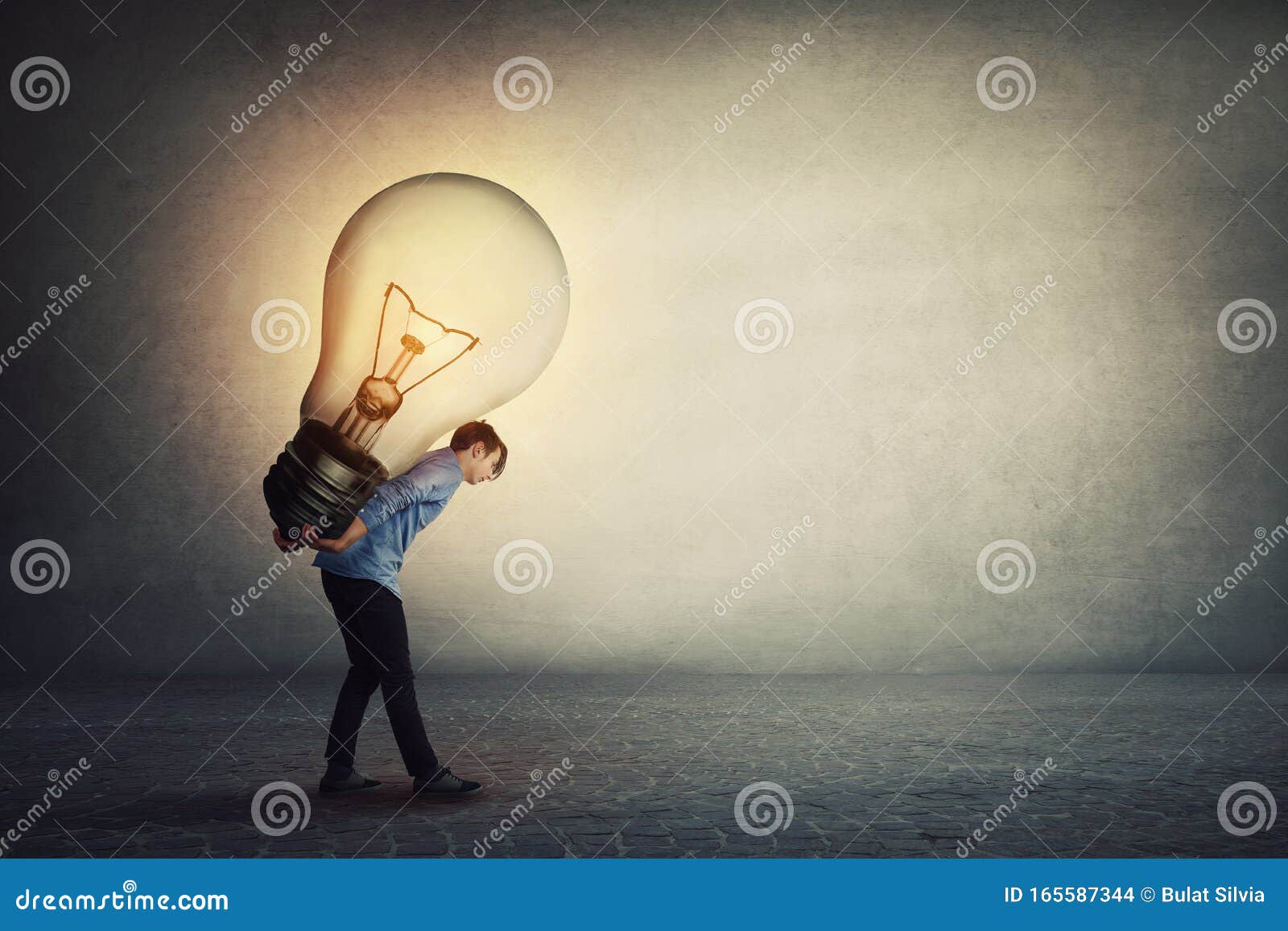 Ingenious Student Guy Carrying a Big Light Bulb on His Back. Overloaded ...