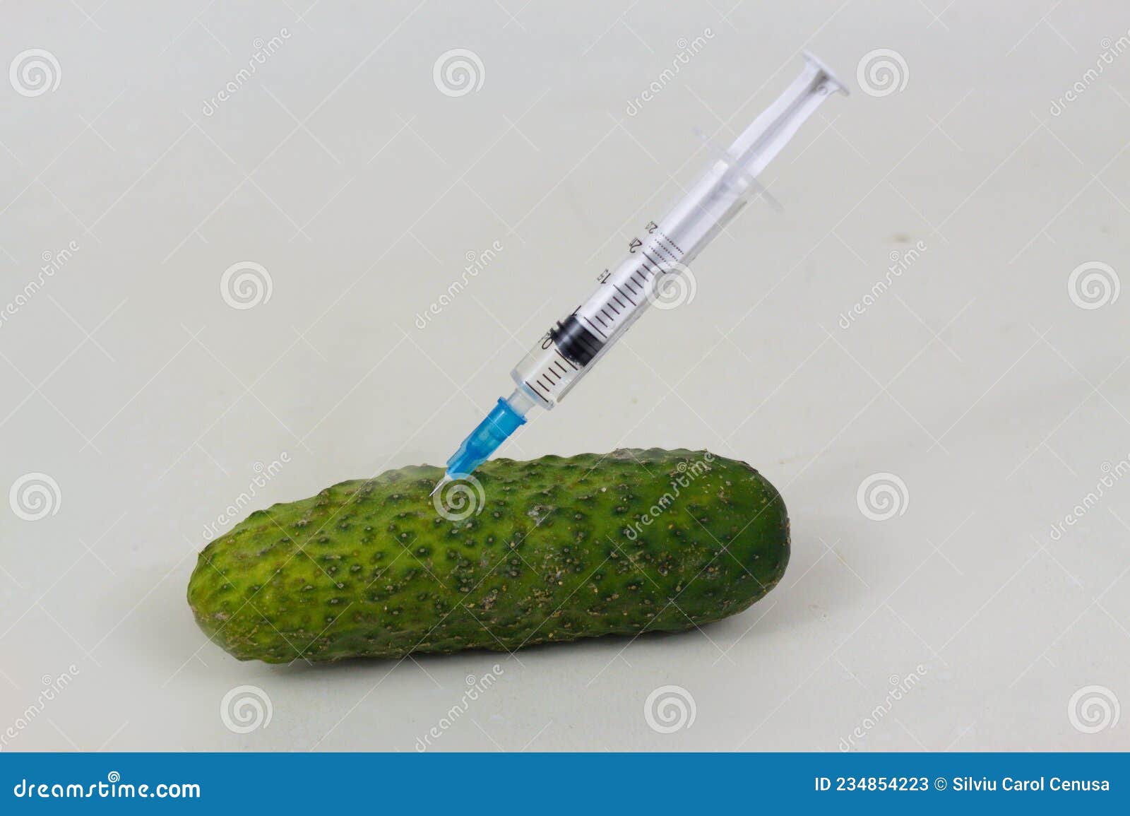Injected Cucumber with Syringe Inside Closeup View Isolated on White ...