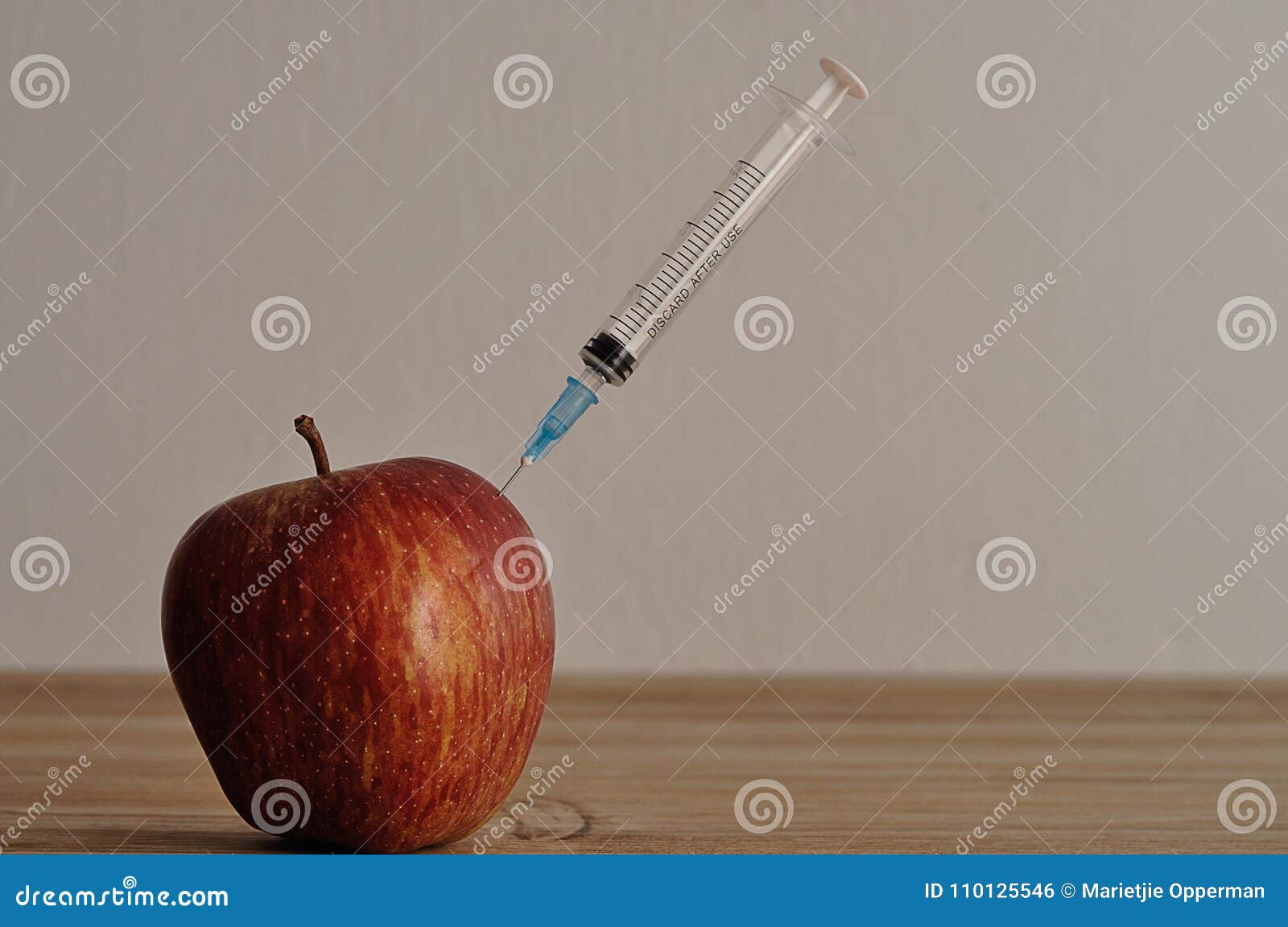 An Injection Needle Stuck into an Apple Stock Photo - Image of biology ...