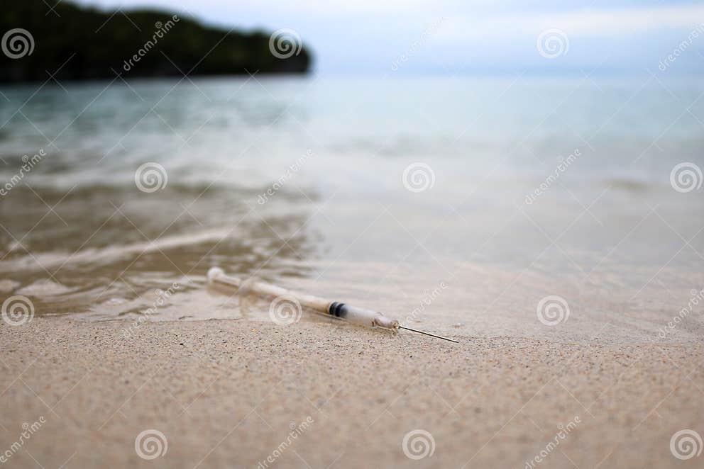 Injection Needles on the Beach. Stock Photo - Image of discarded ...