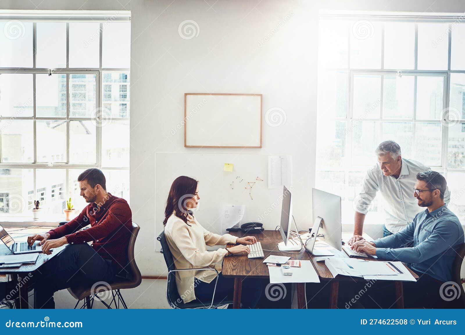 The Inner Workings of a Creative Office. a Group of Colleagues Working ...