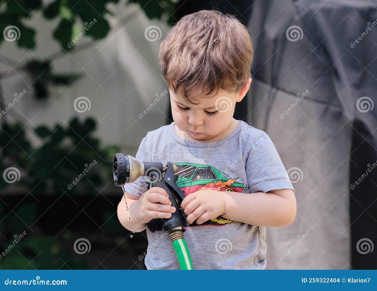 Inquisitive Toddler is Exploring Objects in the Backyard Stock Photo ...