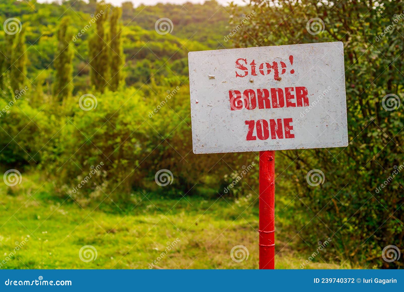 Inscription or Text in English STOP BORDER ZONE. Warning Post about the ...