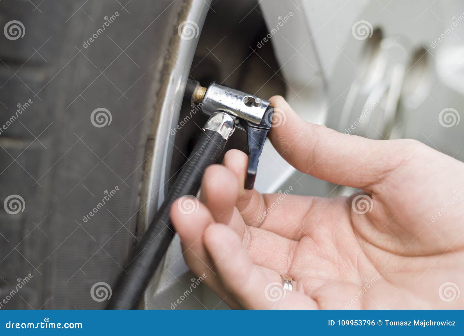 Insert the Tip into the Tire Valve and Pump the Car Wheel Stock Photo ...
