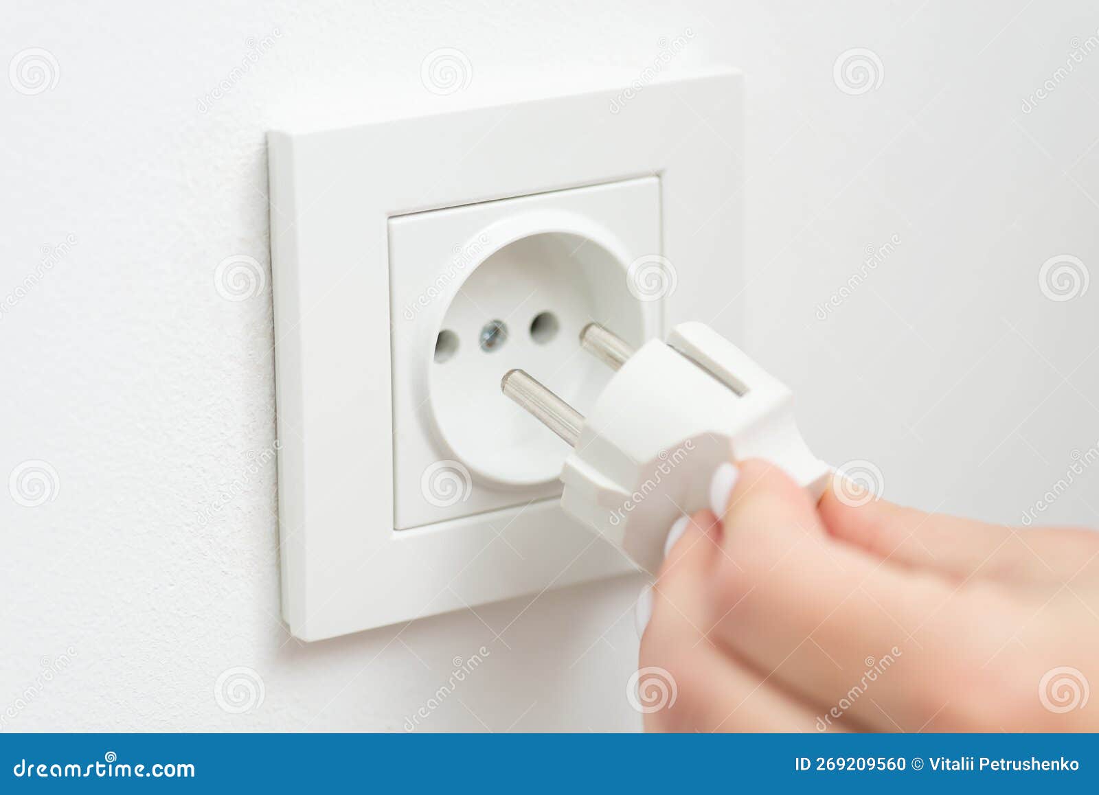 Inserting the Electrical Plug into Outlet of the Wall, White Colour ...