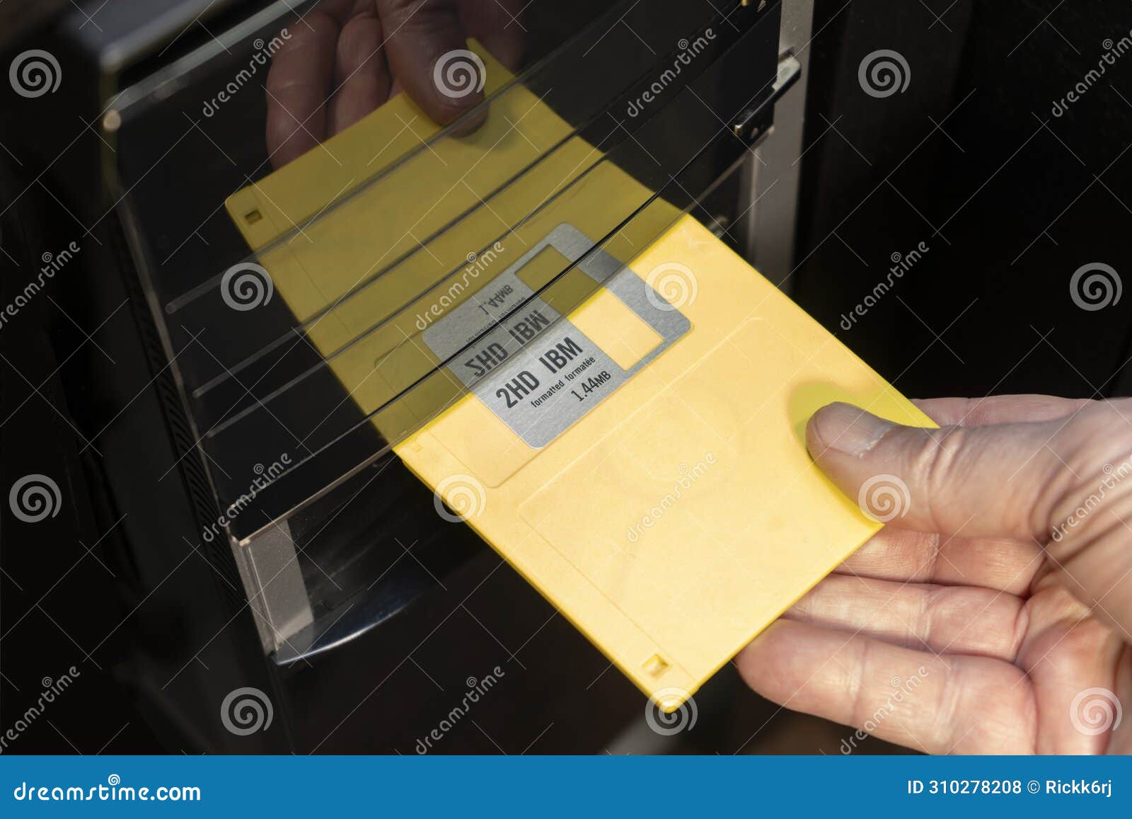 Inserting an Old 3 and a Half Inch Floppy Disk into a Desktop Computer ...