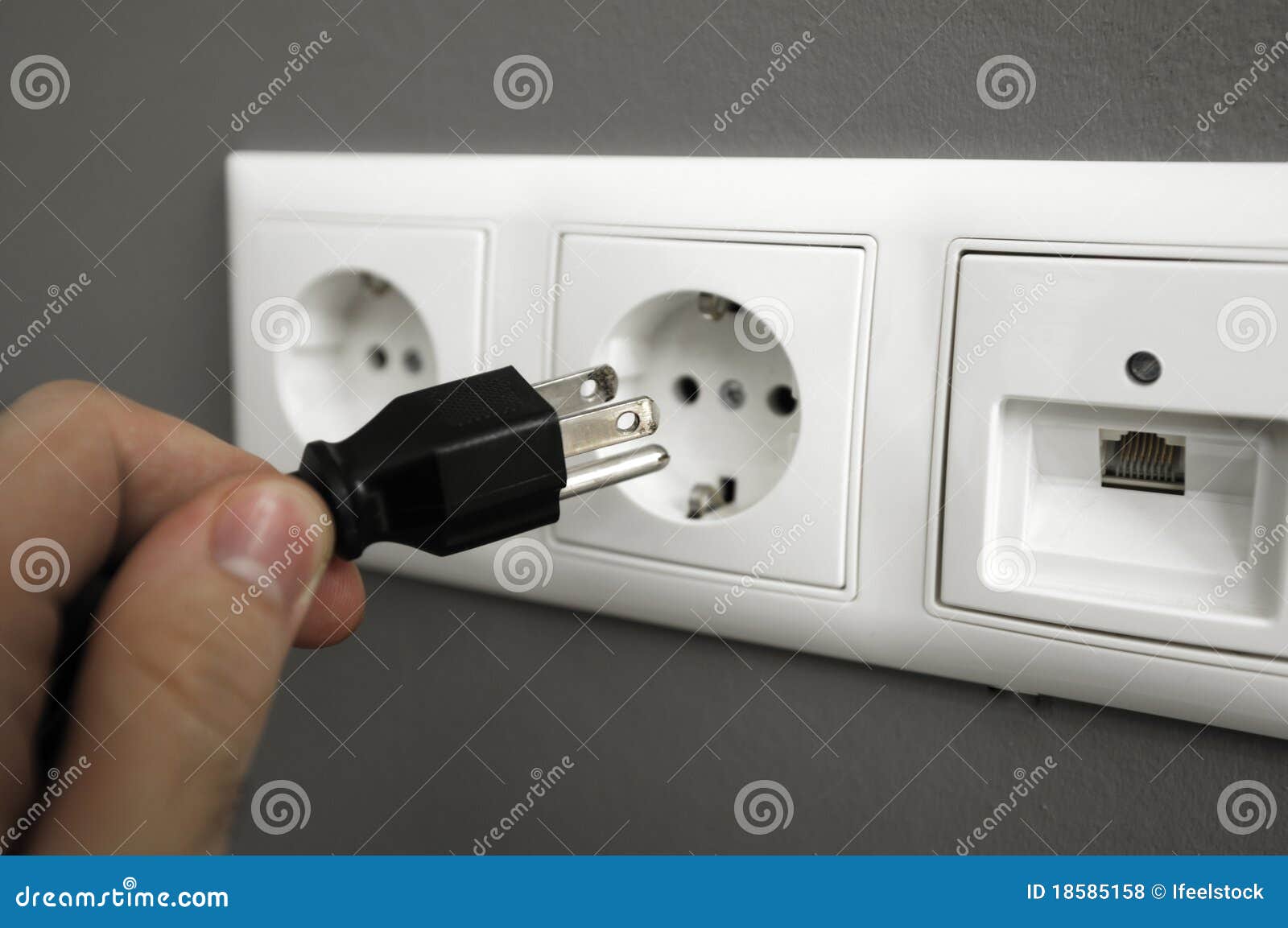 Inserting plug in outlet stock photo. Image of connection - 18585158