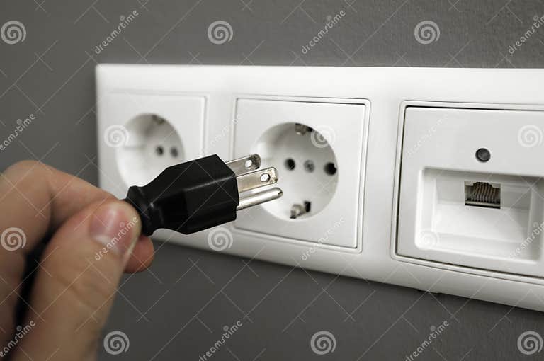 Inserting plug in outlet stock photo. Image of connection - 18585158